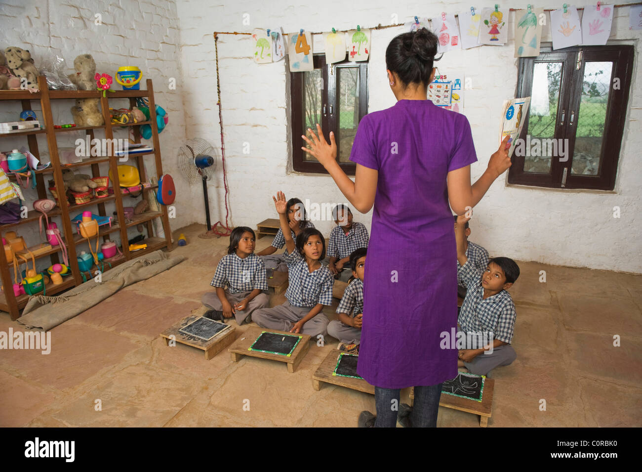 Woman teaching students in a classroom Stock Photo - Alamy