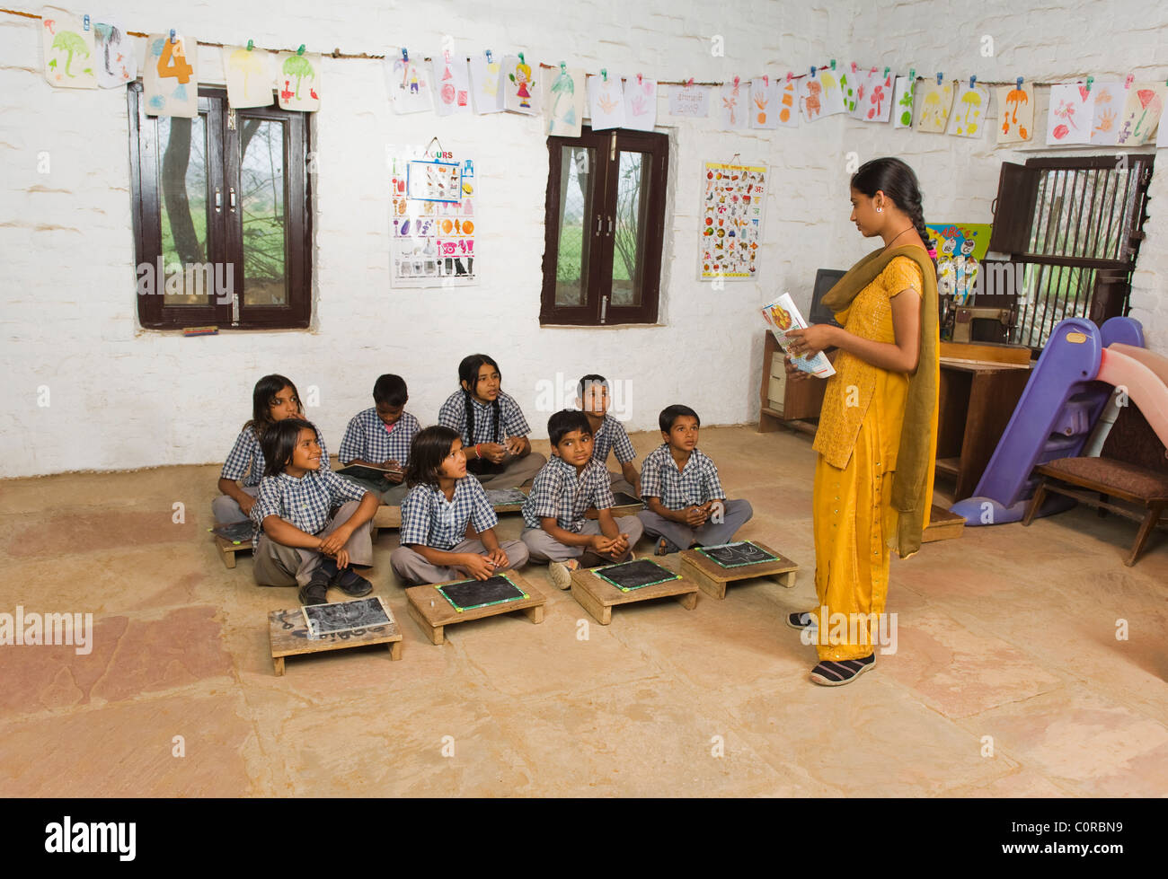 Woman teaching students in a classroom Stock Photo - Alamy