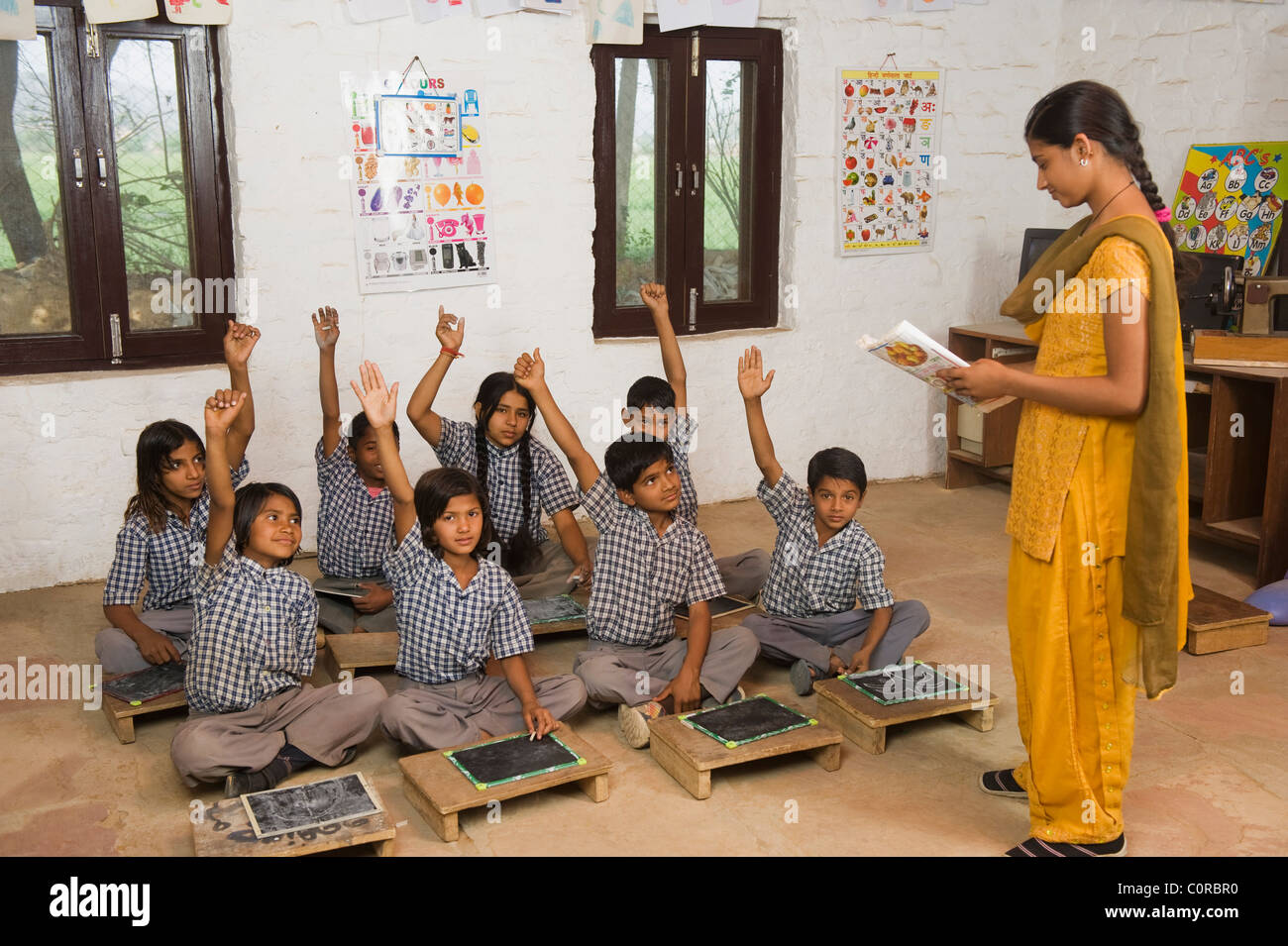 Woman teaching students in a classroom Stock Photo - Alamy