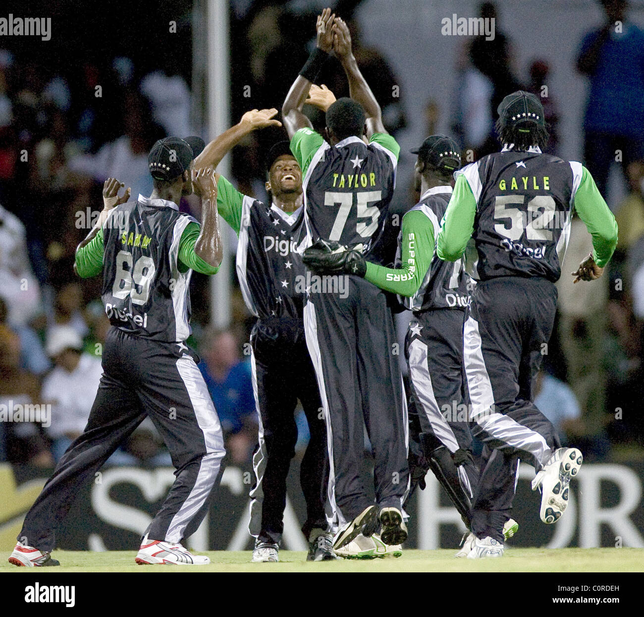 Superstars celebrate the fall of a wicket Stanford Super Series ...