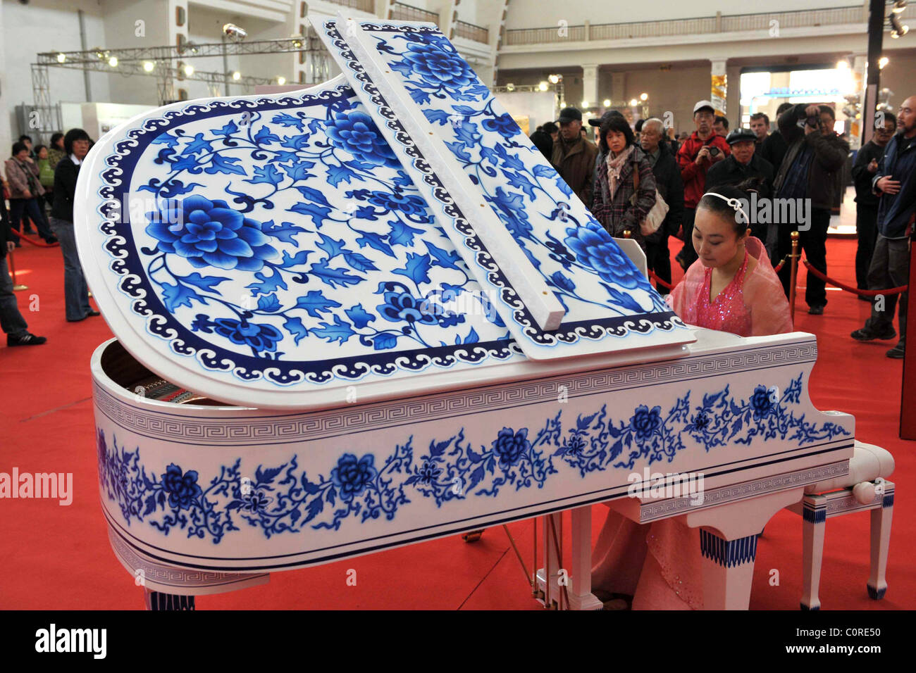 * ONE-OF-A-KIND PIANO A young girl plays a blue and white porcelain ...