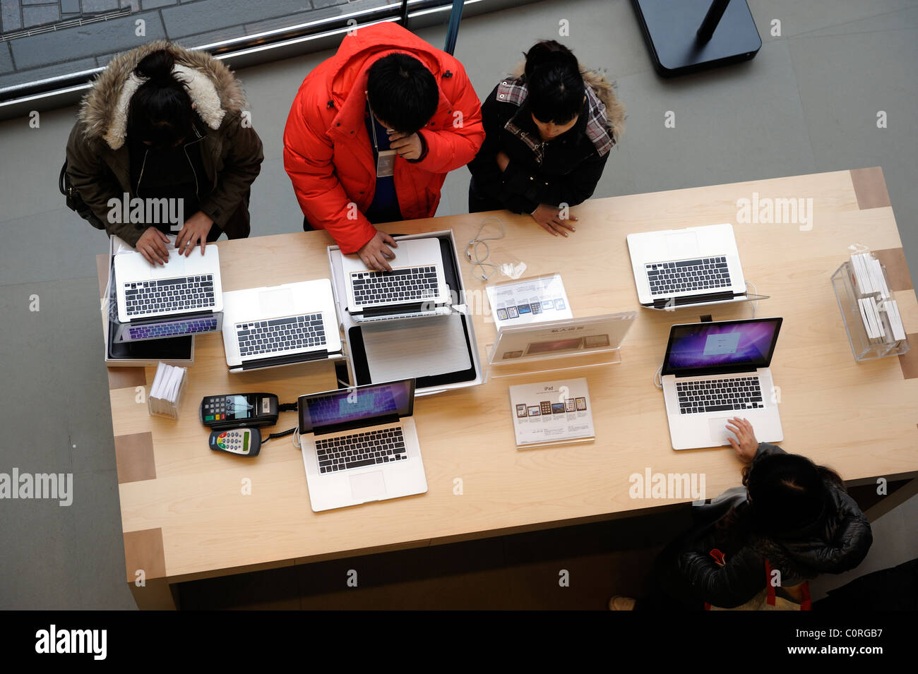 People trying out Apple Macbooks in the Apple Store in Beijing, China ...