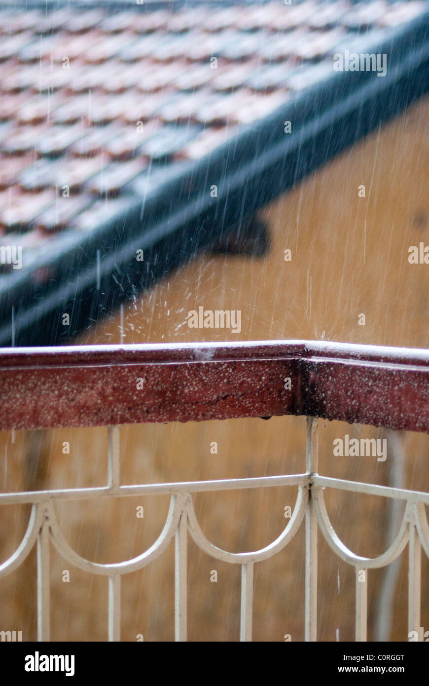 Heavy rain bouncing of the balcony balustrade Stock Photo - Alamy
