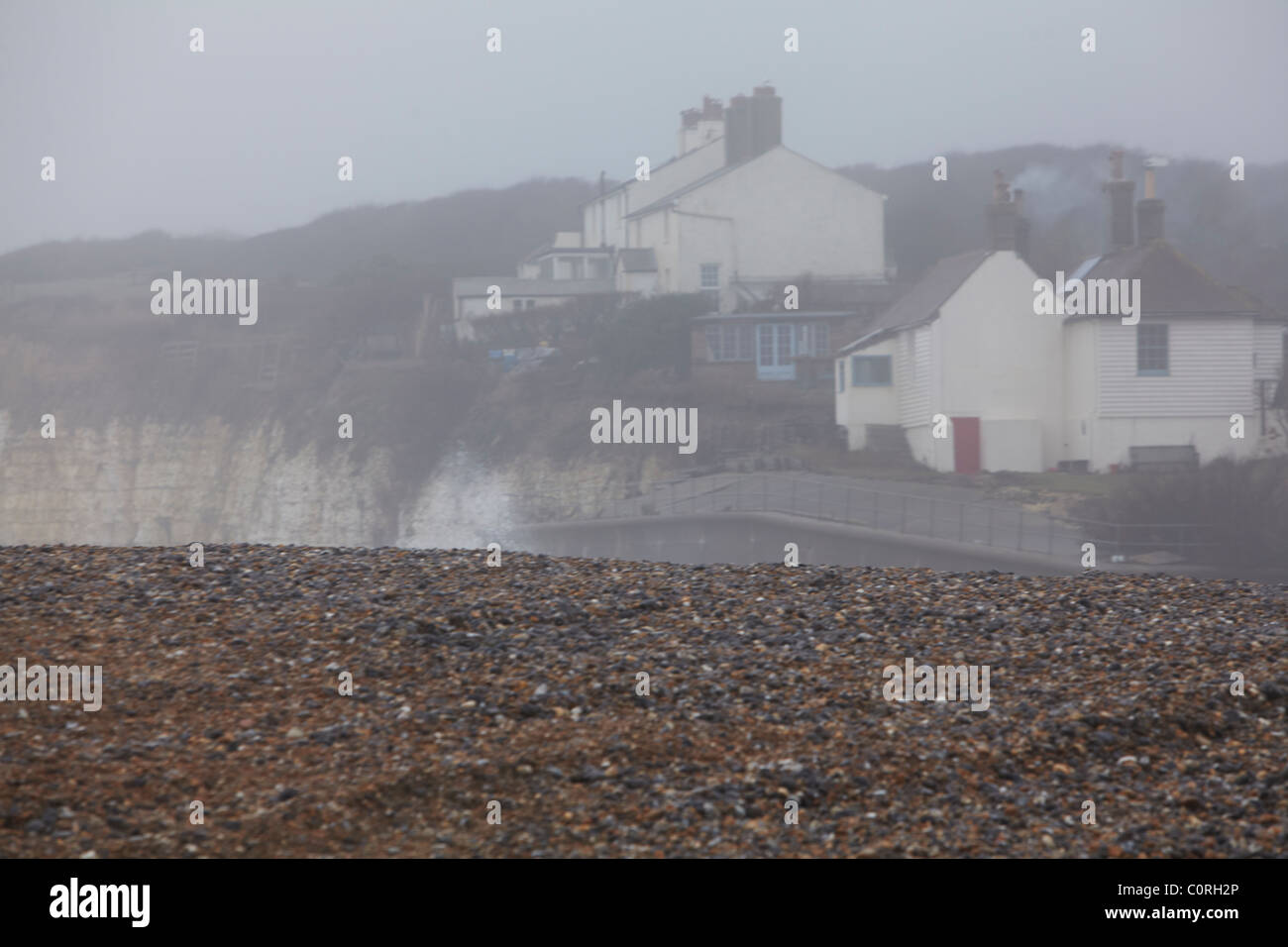 misty beach cliff and houses Stock Photo - Alamy