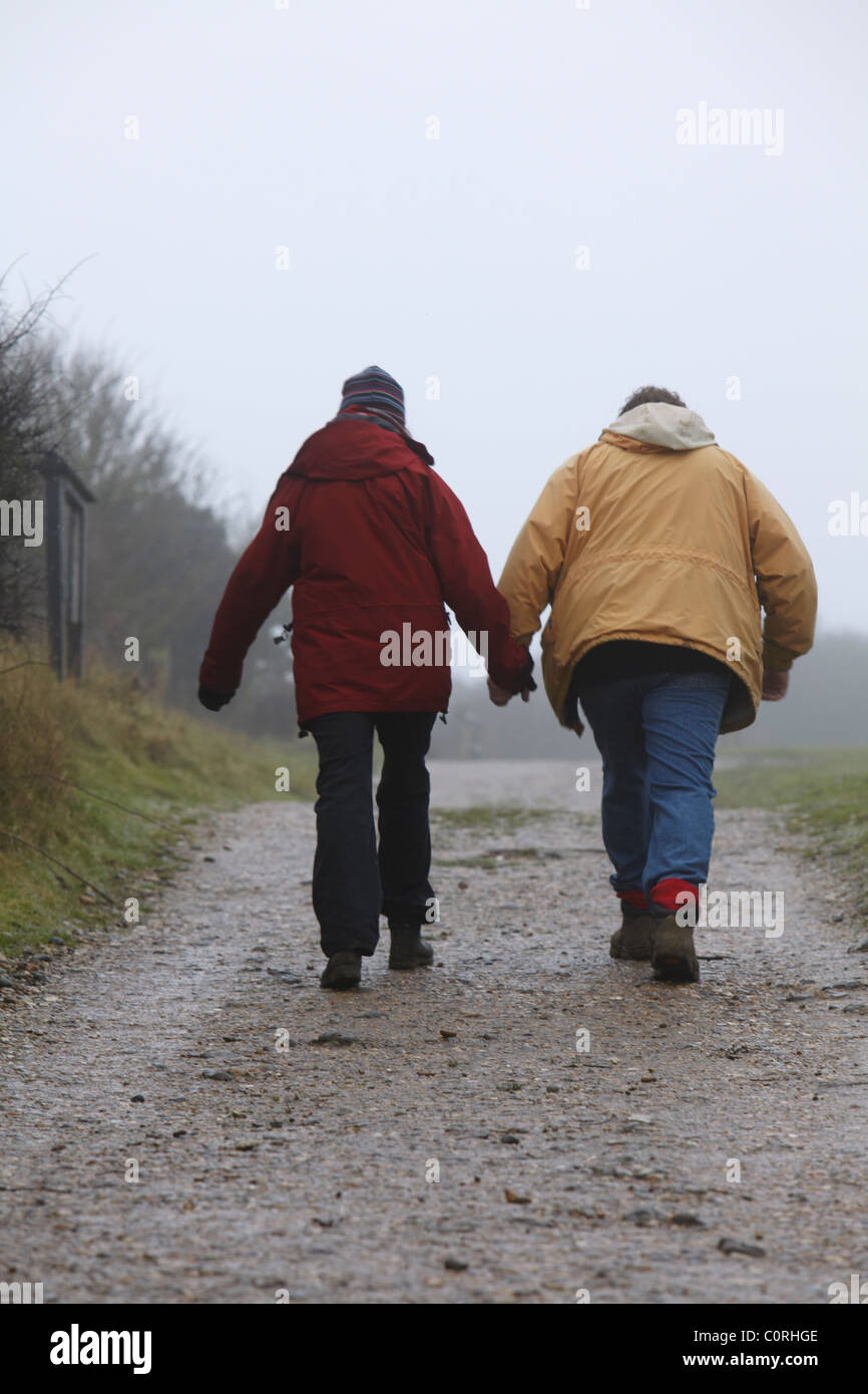 Middle aged couple rambling-walking away Stock Photo - Alamy