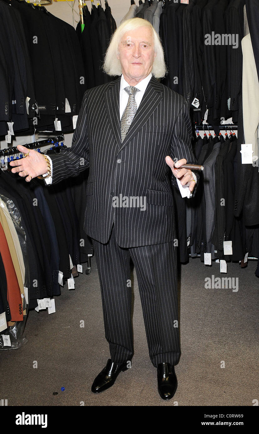 Sir Jimmy Savile poses in a suit at Warren Gold at Gold's Factory ...