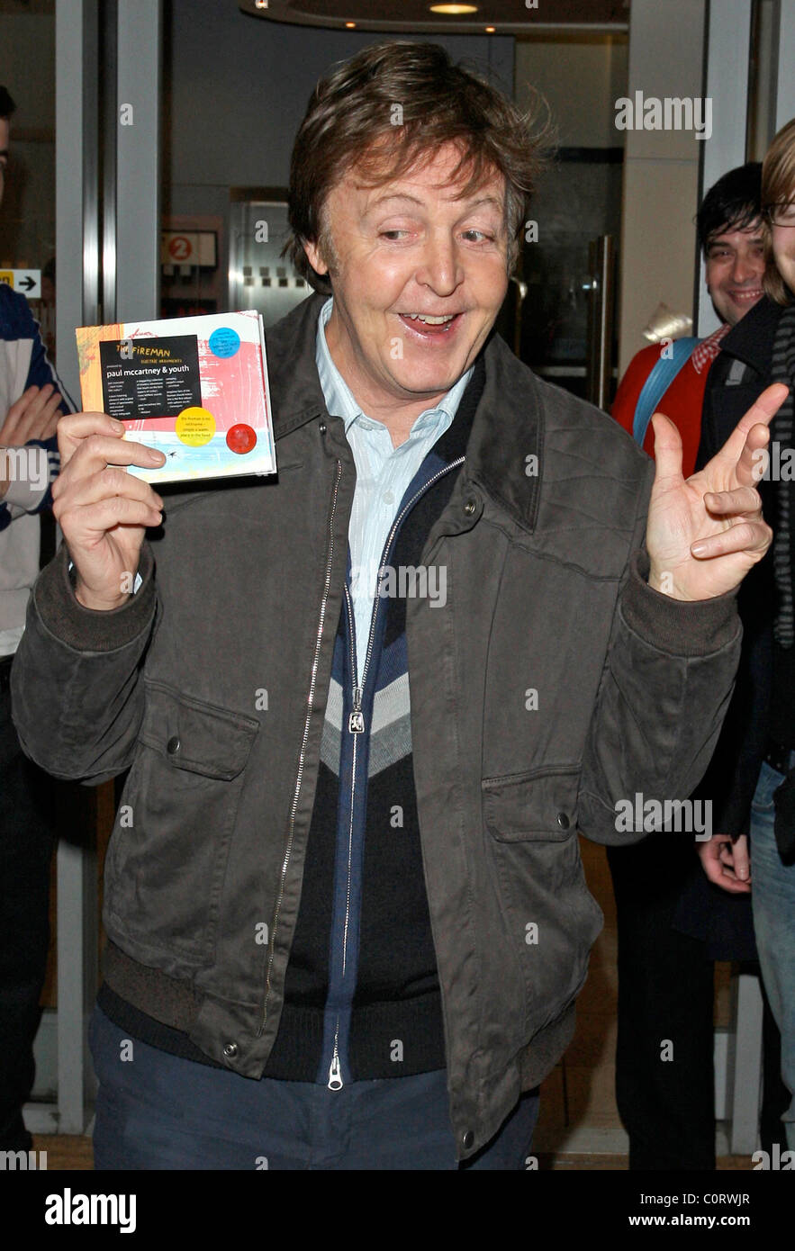 Paul McCartney holds up the new album from his band 'The Fireman' as he ...