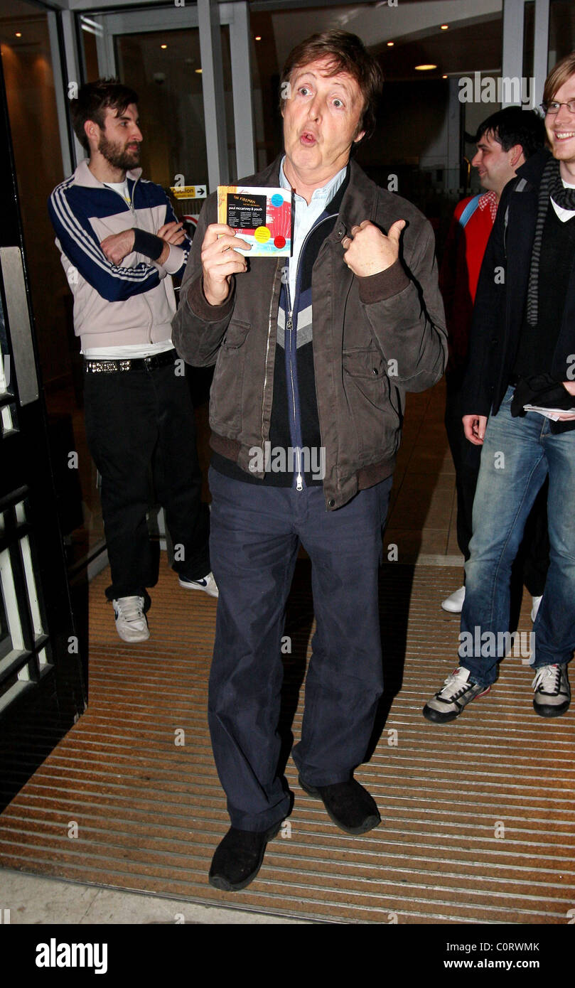 Paul McCartney holds up the new album from his band 'The Fireman' as he ...