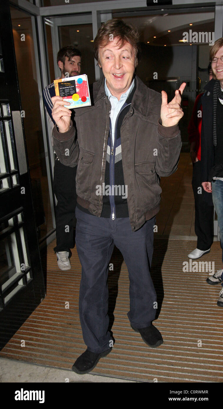 Paul McCartney holds up the new album from his band 'The Fireman' as he ...