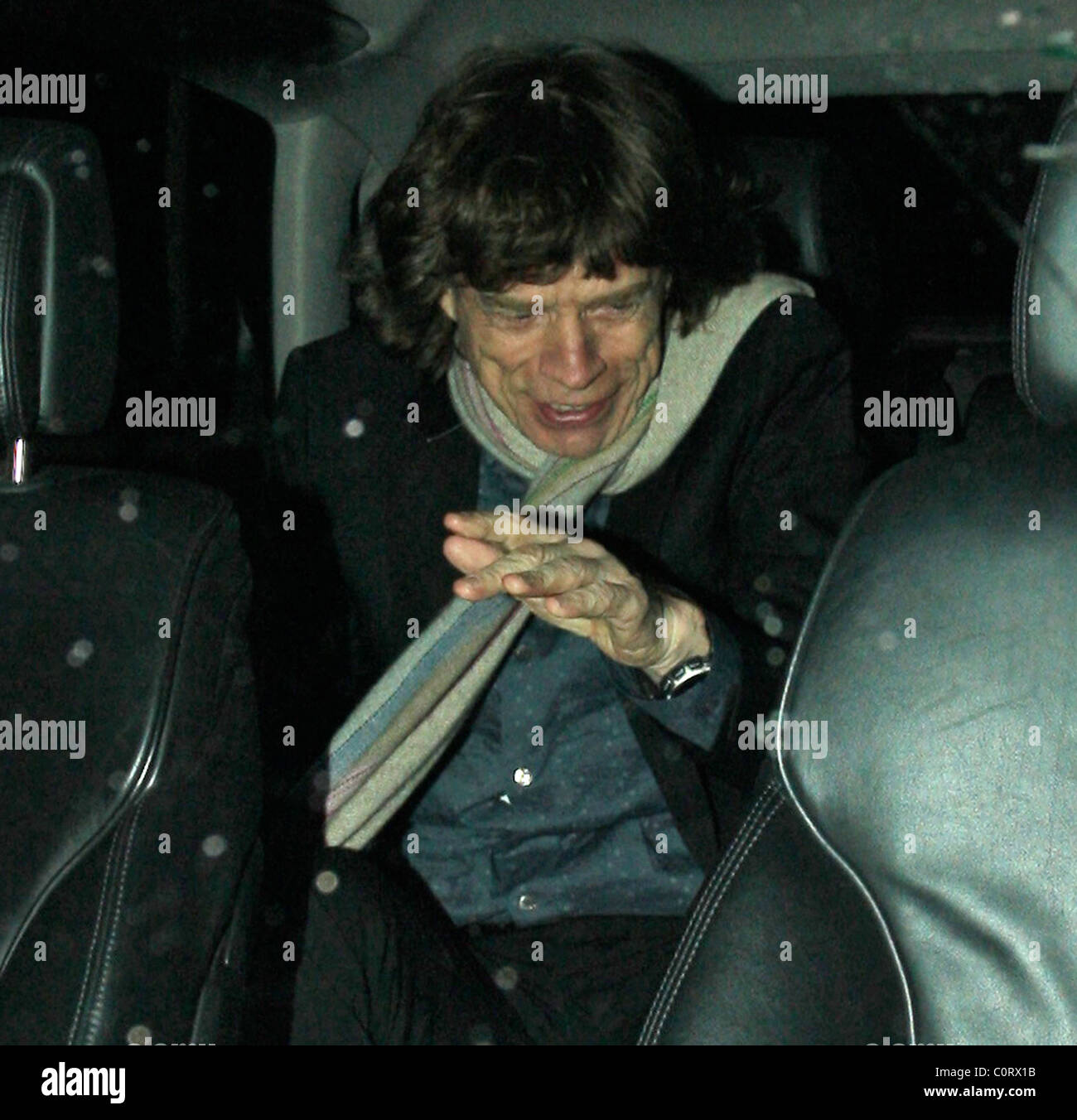 Mick Jagger waves his fists and karate chops as he fights his way ...