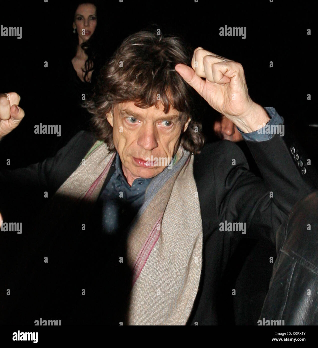 Mick Jagger waves his fists and karate chops as he fights his way ...