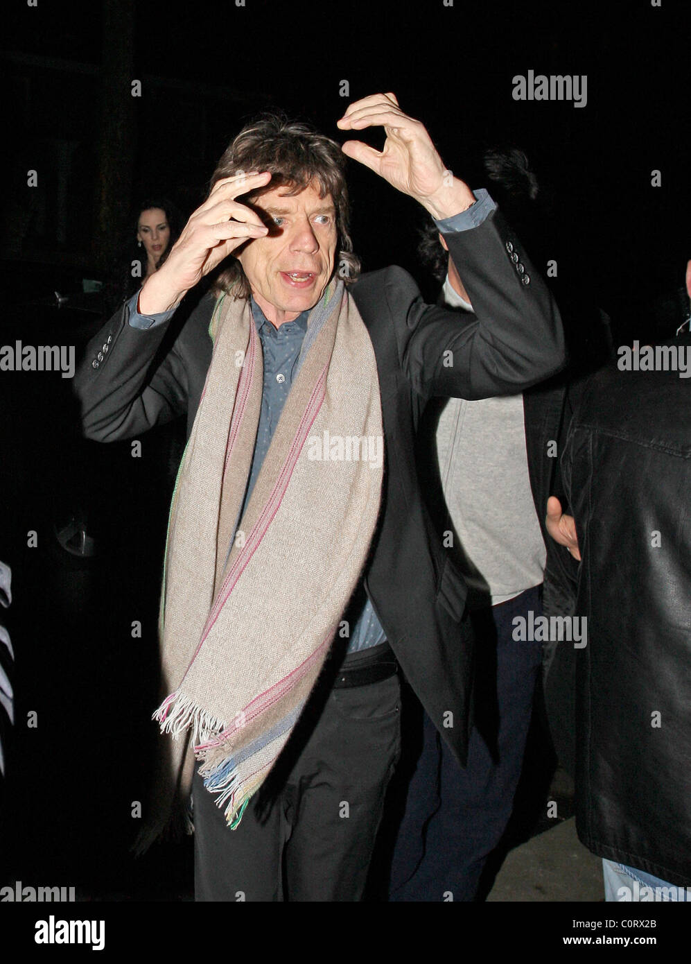 Mick Jagger waves his fists and karate chops as he fights his way ...