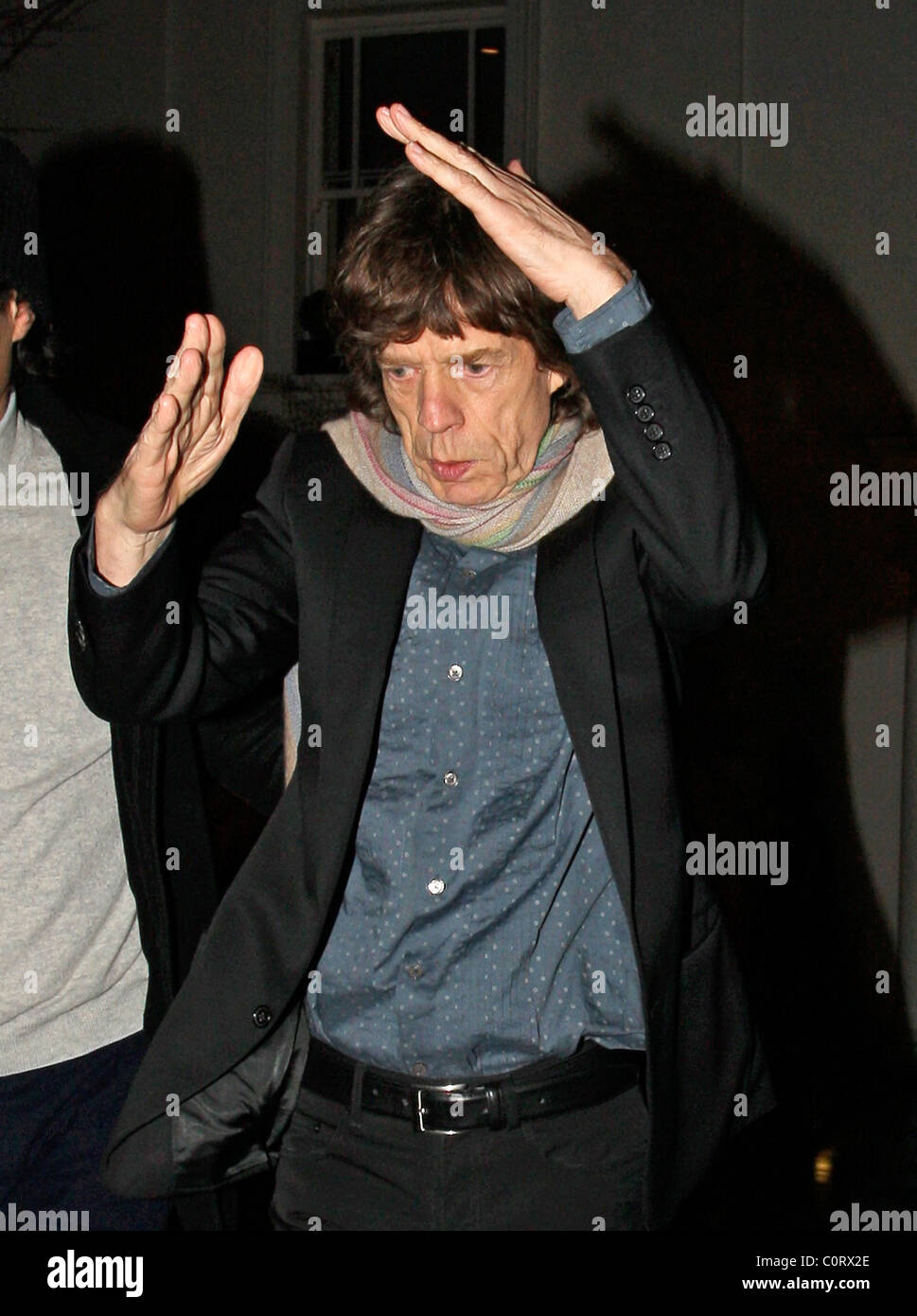 Mick Jagger waves his fists and karate chops as he fights his way ...