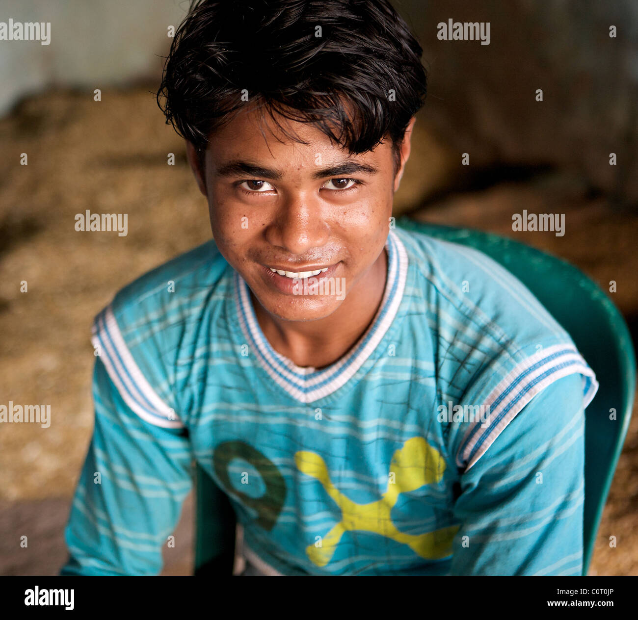 Portrait of Keralite boy preparing fish fillets in Fort Cochin market ...