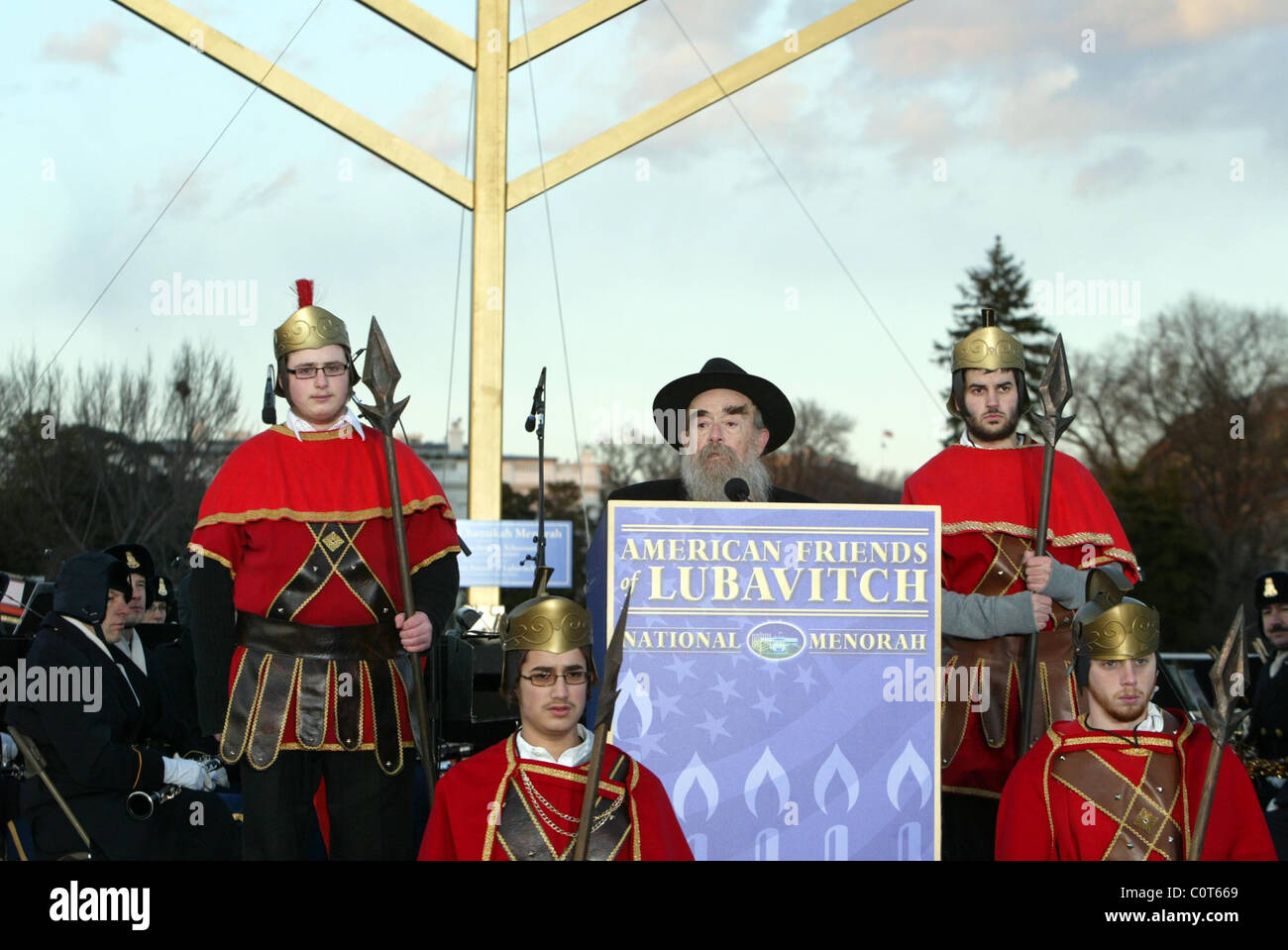 Rabbi Shem Tov addresses the crowd as soldiers in costume stand guard ...