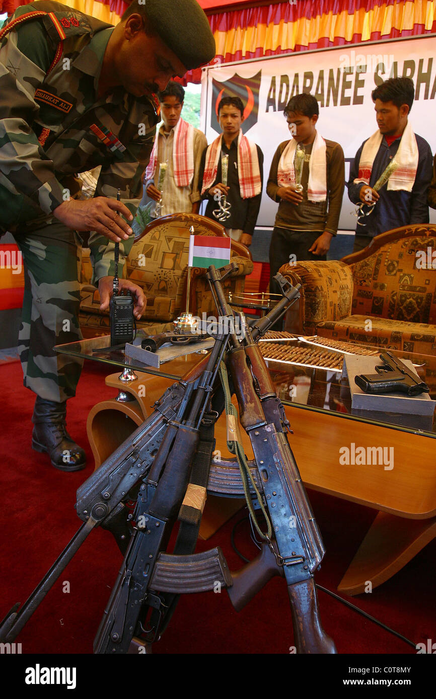 Indian army personnel arrange arms and ammunitions during a surrender ...