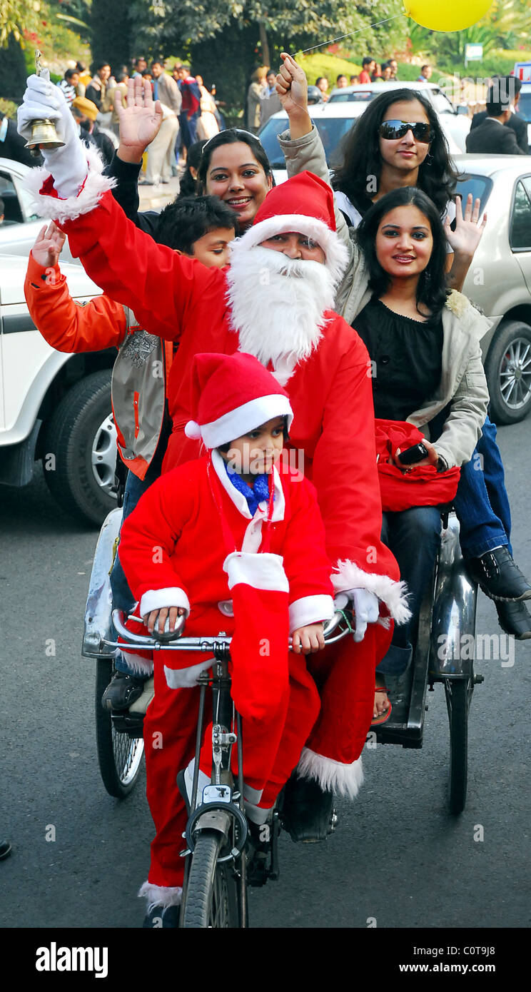 Santa Claus rides a tricycle through the street Chandigarh, India - 25. ...