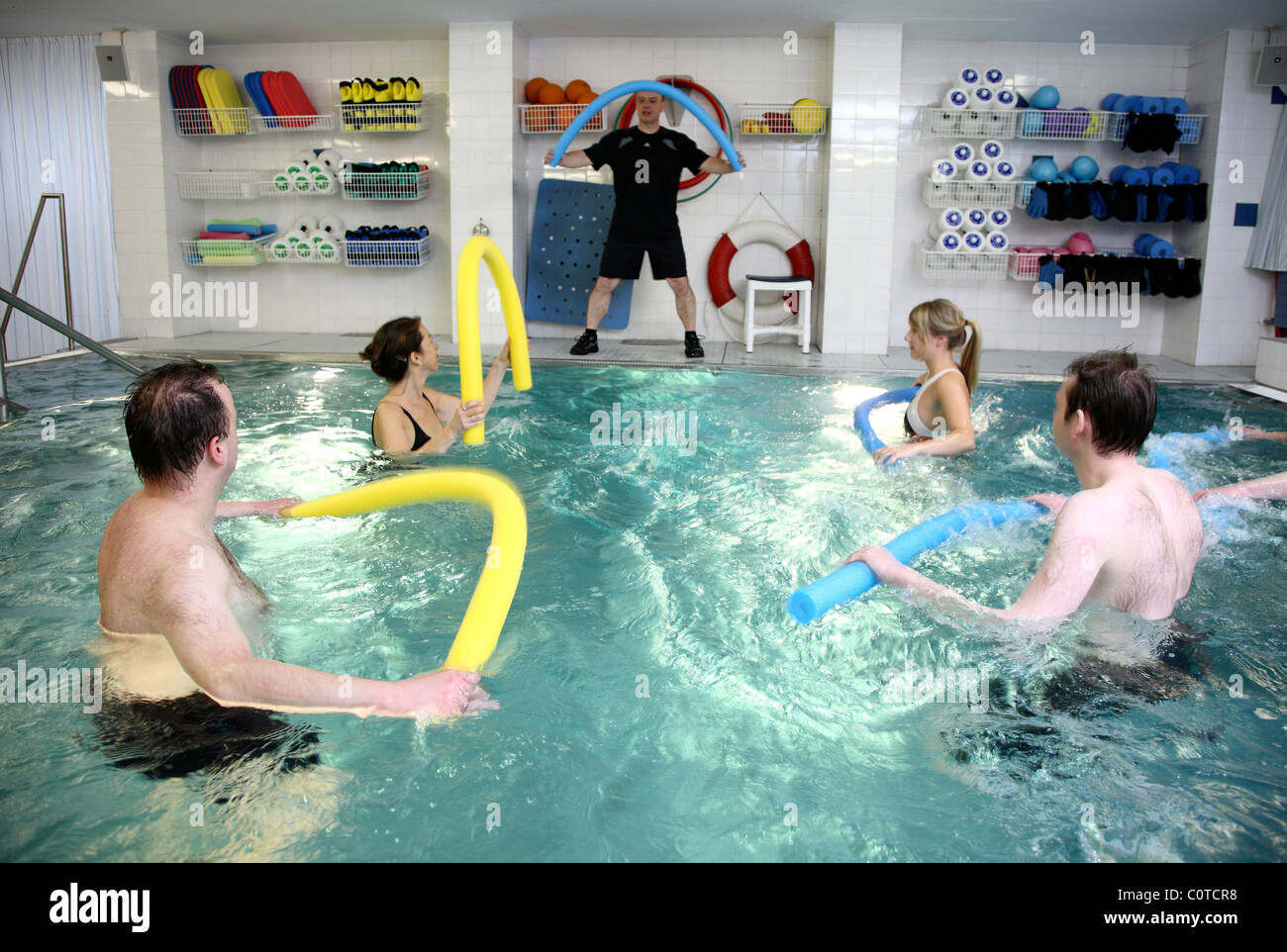 Water gymnastics, aqua aerobics as a physical therapy. Patients in a ...
