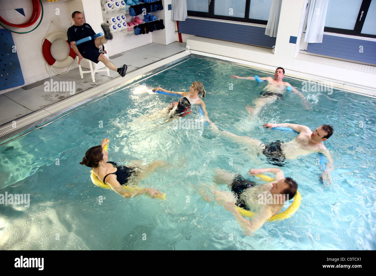 Water gymnastics, aqua aerobics as a physical therapy. Patients in a ...