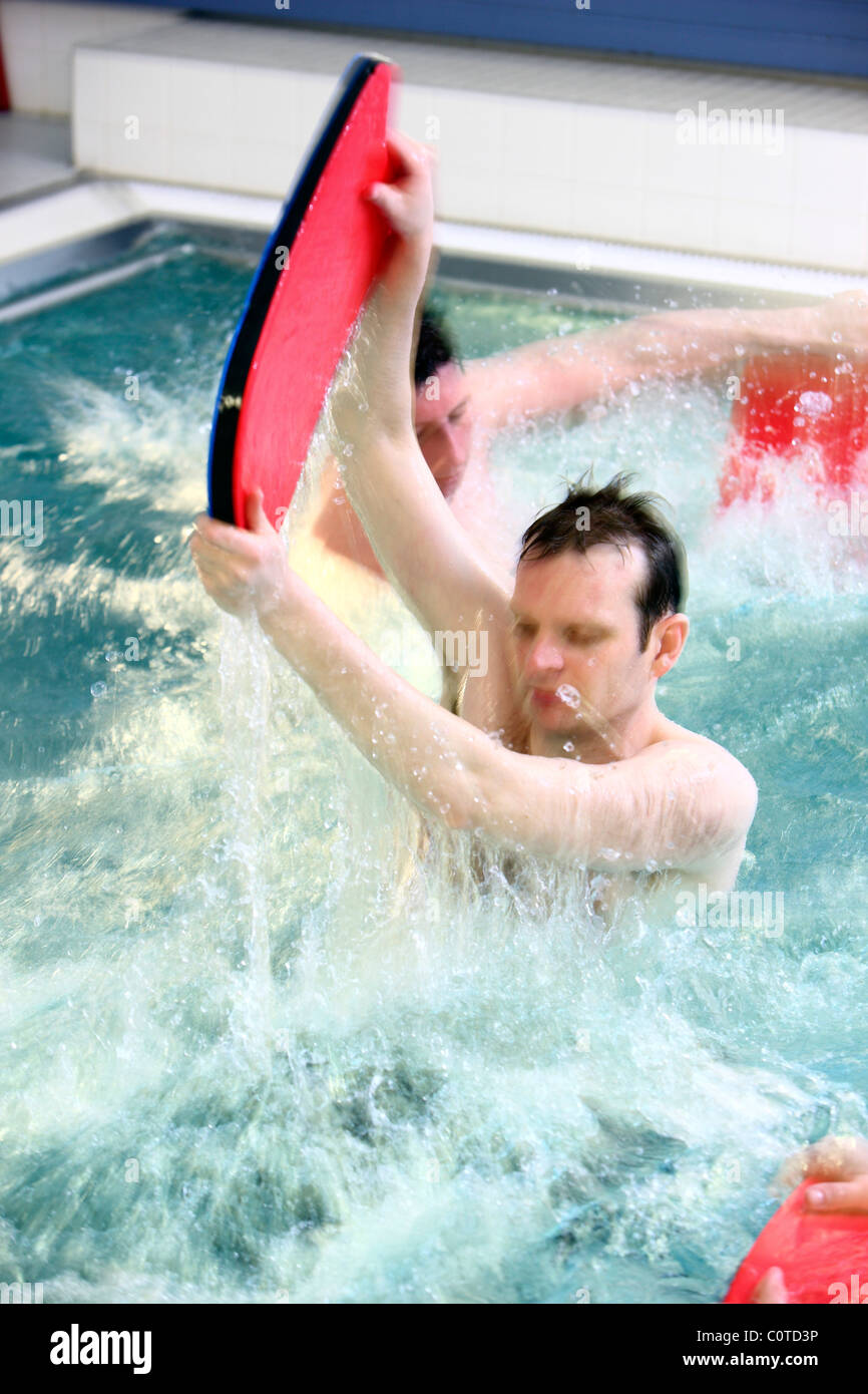 Water gymnastics, aqua aerobics as a physical therapy. Patients in a ...
