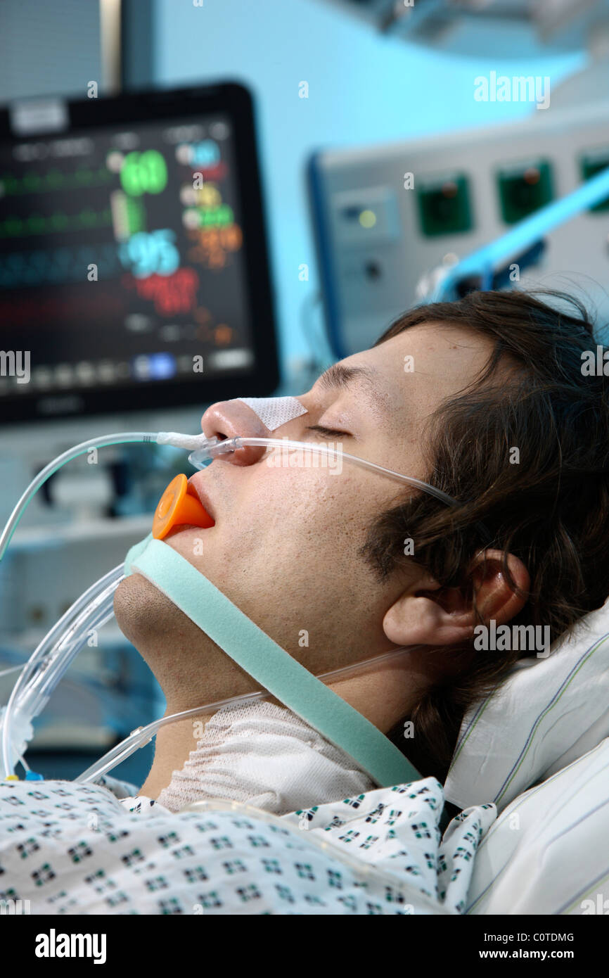 Intensive care unit in a hospital. A patient is connected to different ...