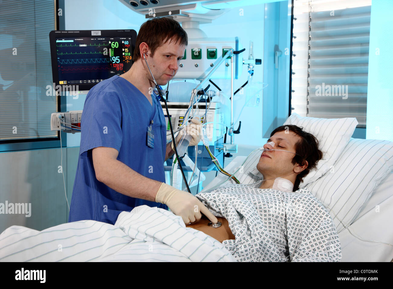 Intensive care unit in a hospital. A patient is connected to different ...