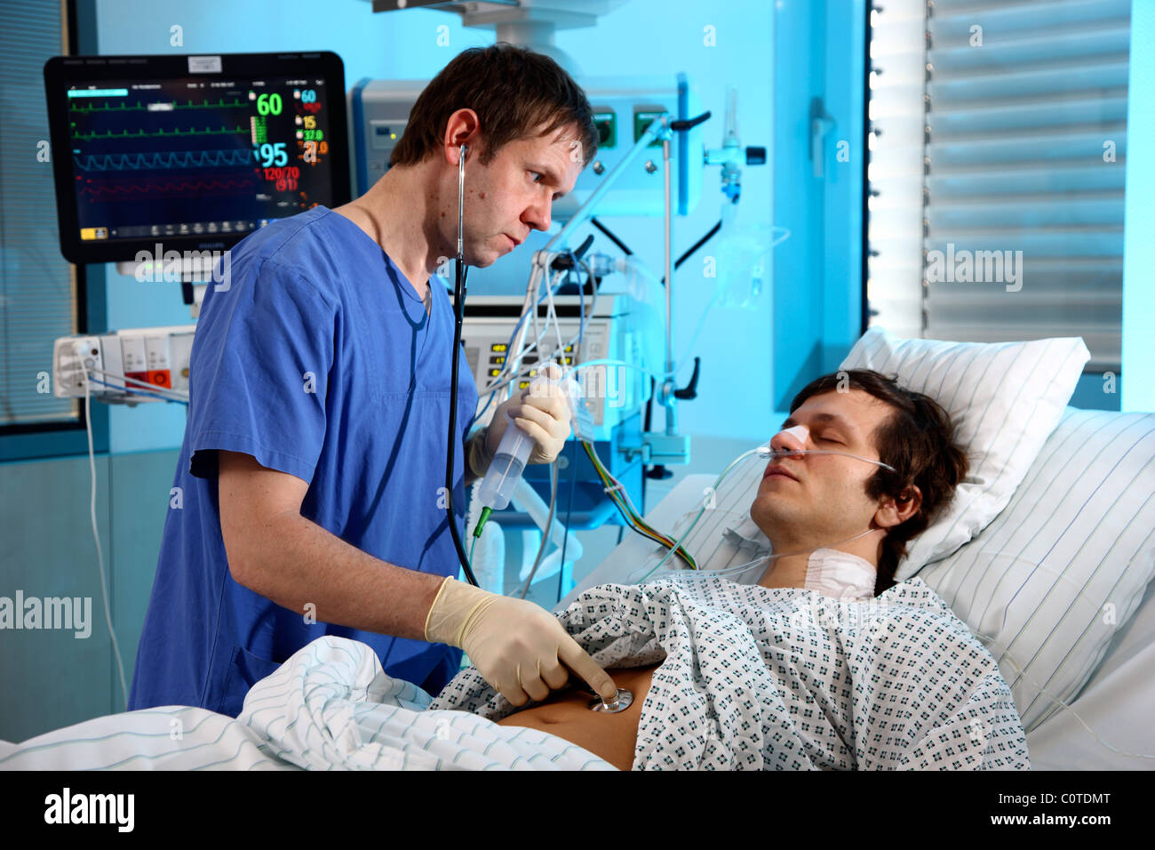 Intensive care unit in a hospital. A patient is connected to different ...