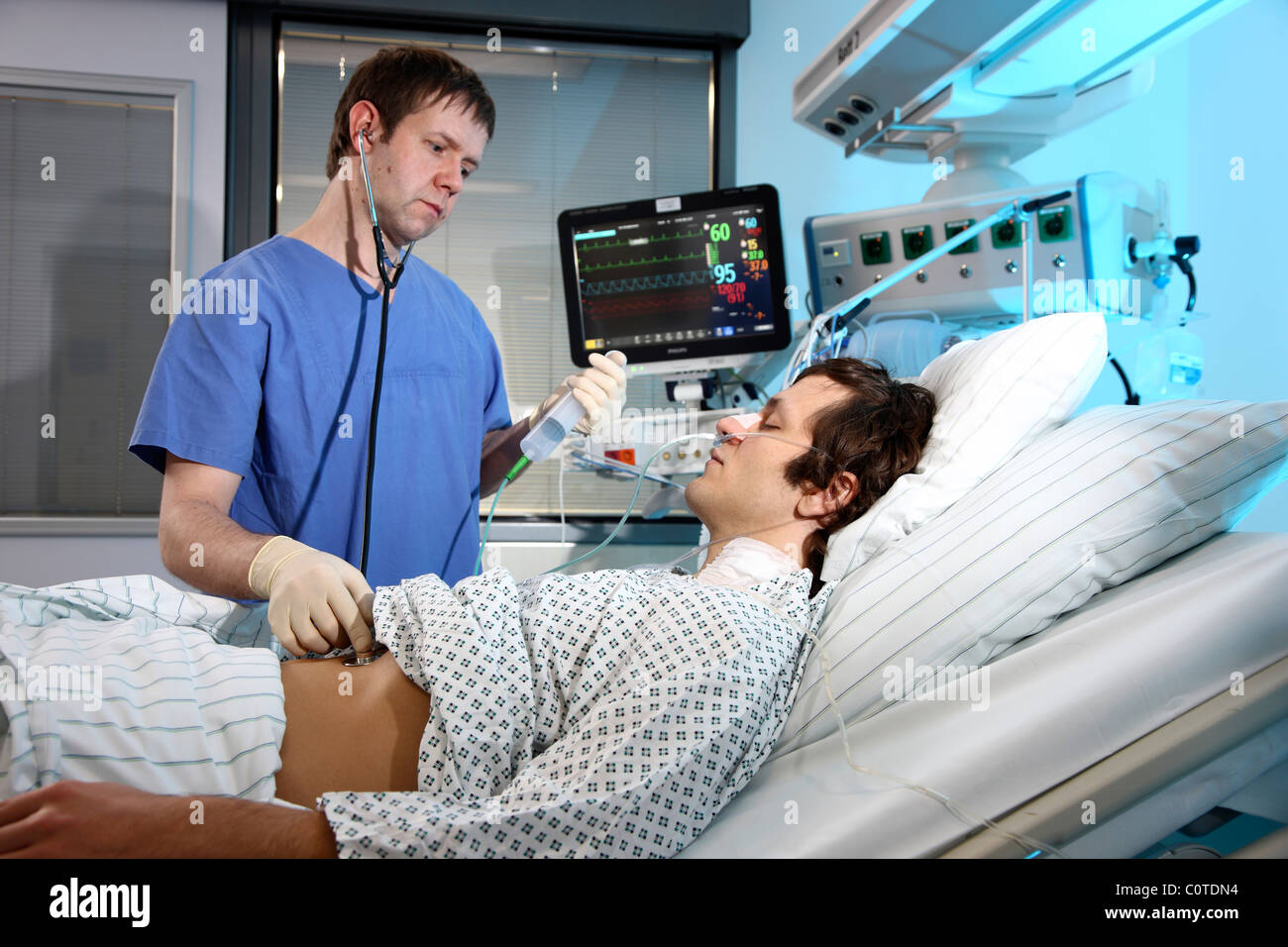 Intensive care unit in a hospital. A patient is connected to different ...