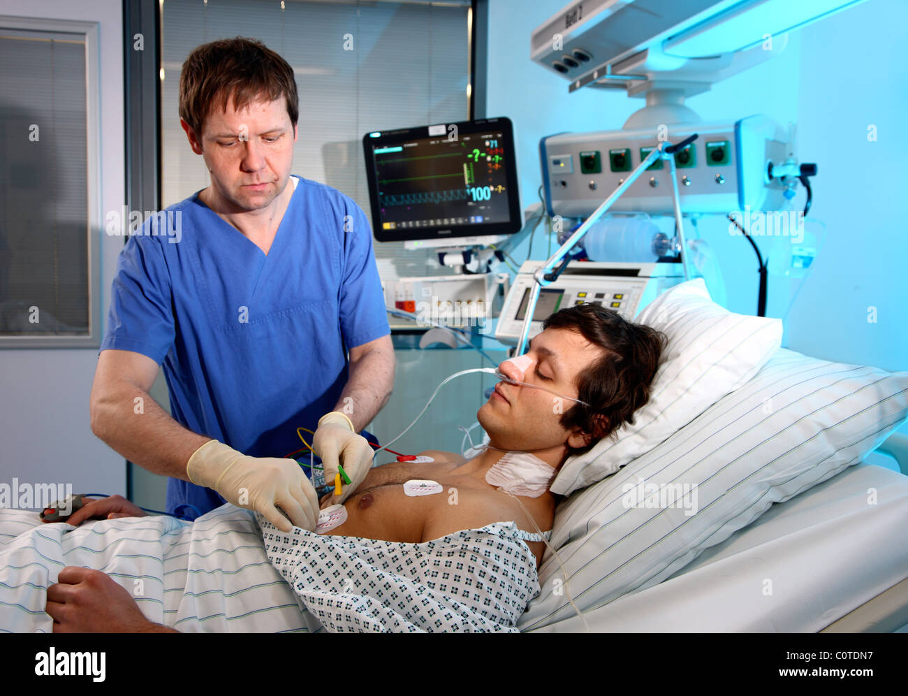 Intensive care unit in a hospital. A patient is connected to different ...