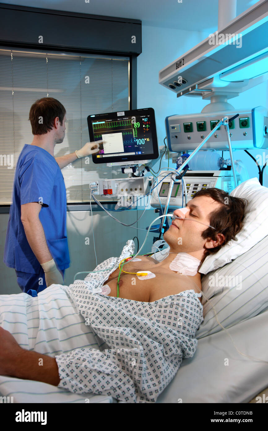Intensive care unit in a hospital. A patient is connected to different ...