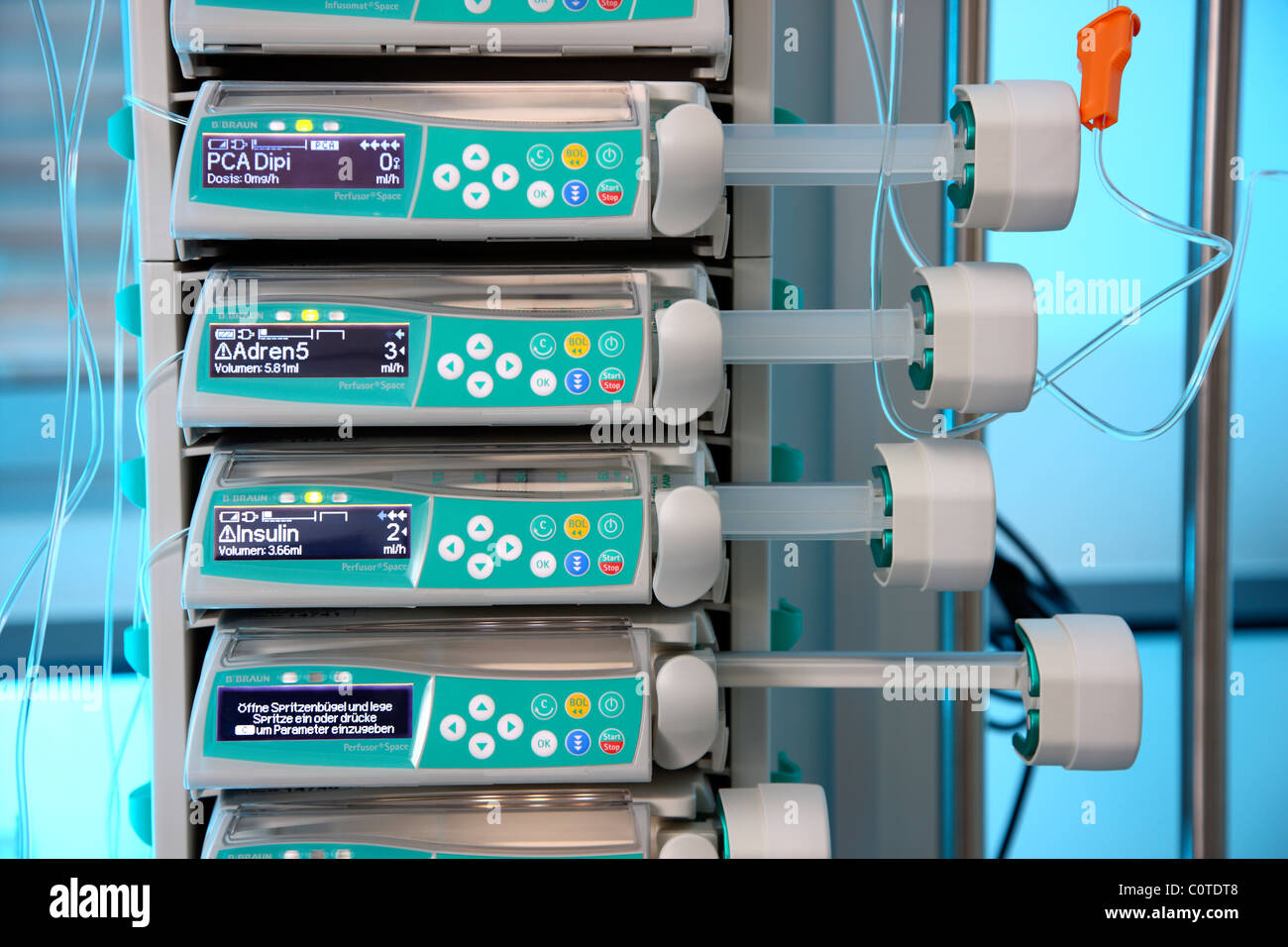 Intensive care unit in a hospital. A patient is connected to different ...