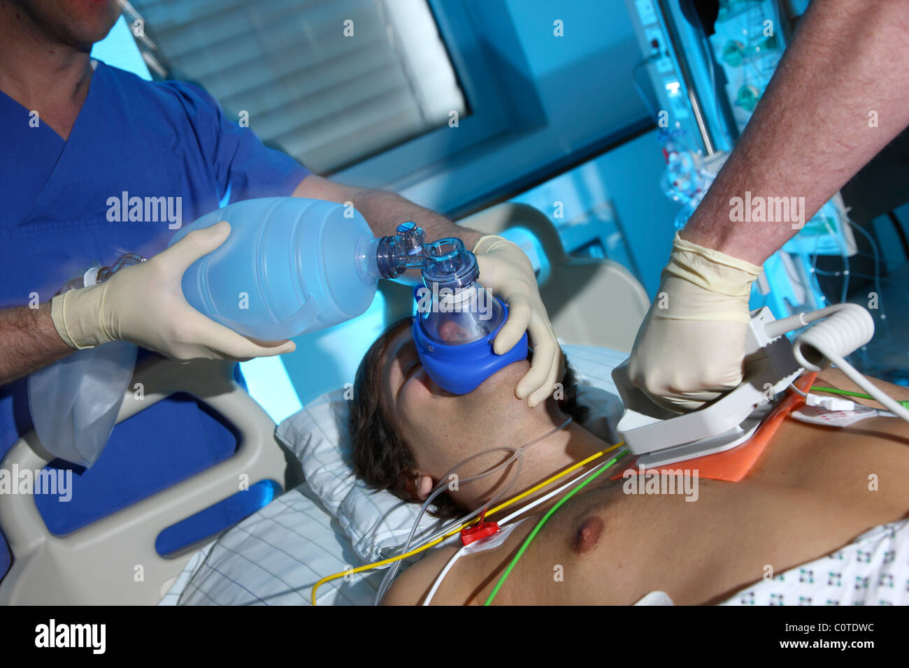 Intensive care unit in a hospital. A patient is connected to different ...