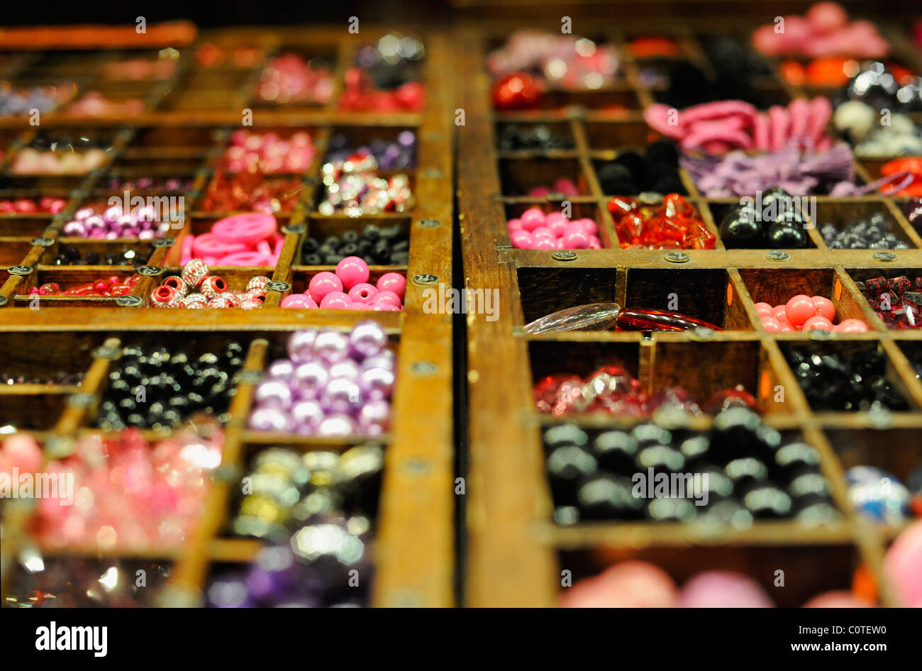 An array of beads in wooden lattice trays Stock Photo - Alamy