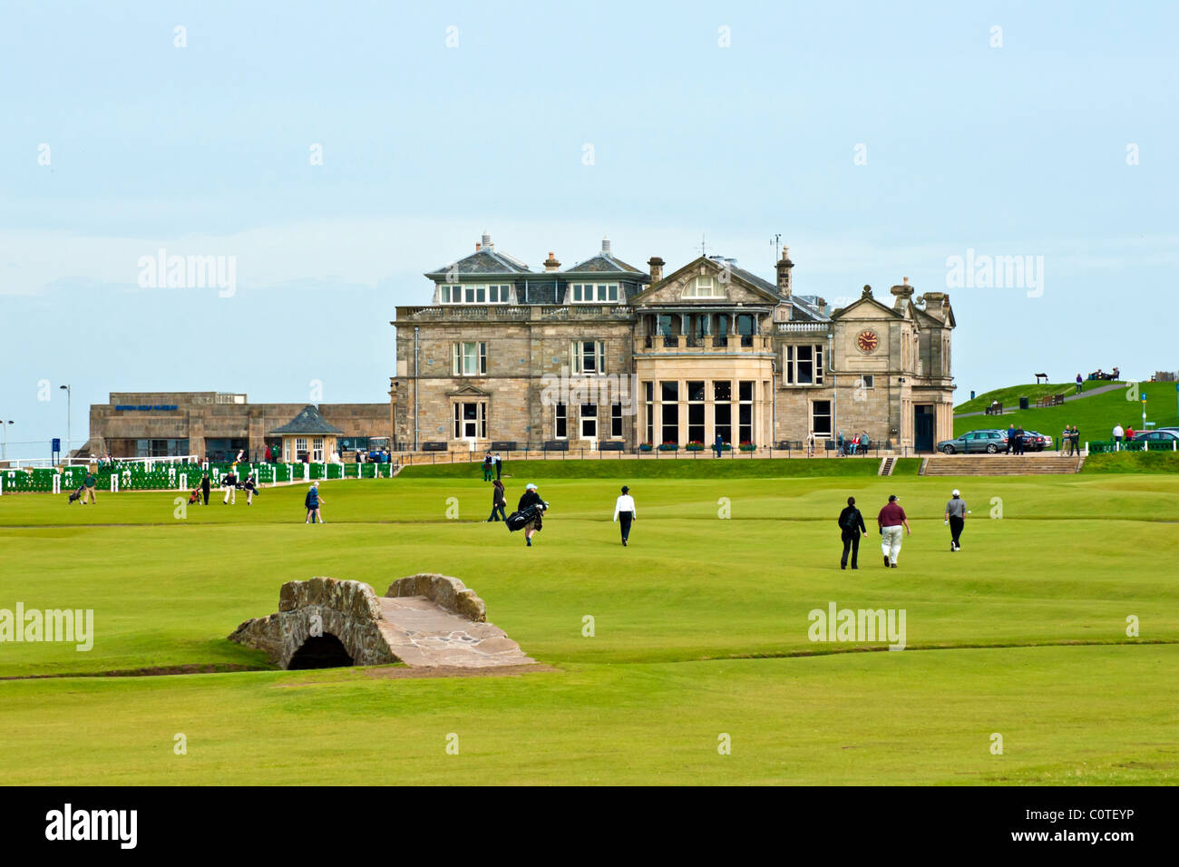 Golfers moving towards18th hole with famous Swilcan Bridge crossing the ...