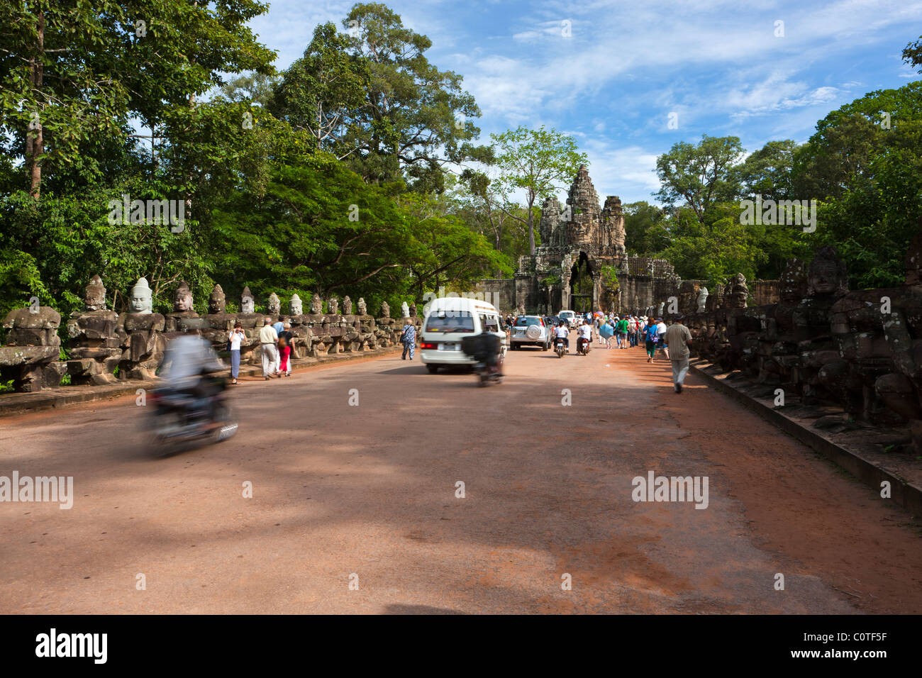 South Gate. Stone sculptures border the bridge to the temple Angkor ...