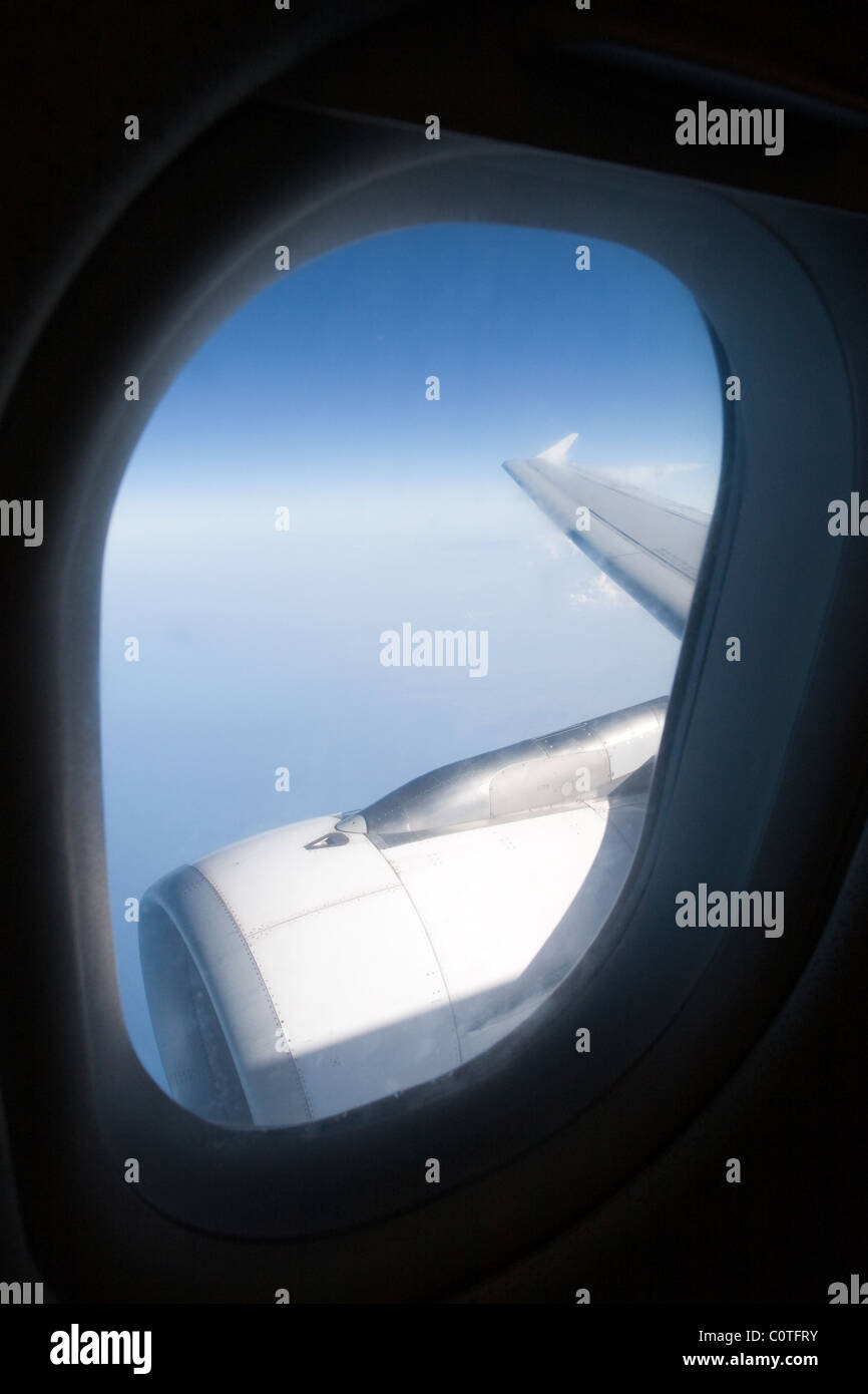airplane window, engine wing and sky view Stock Photo - Alamy