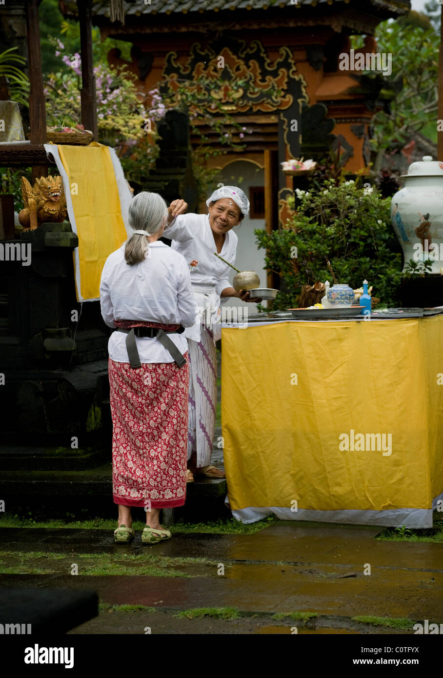 A woman priest at the Hindu temple in Bali, Indonesia, known as Besakih ...