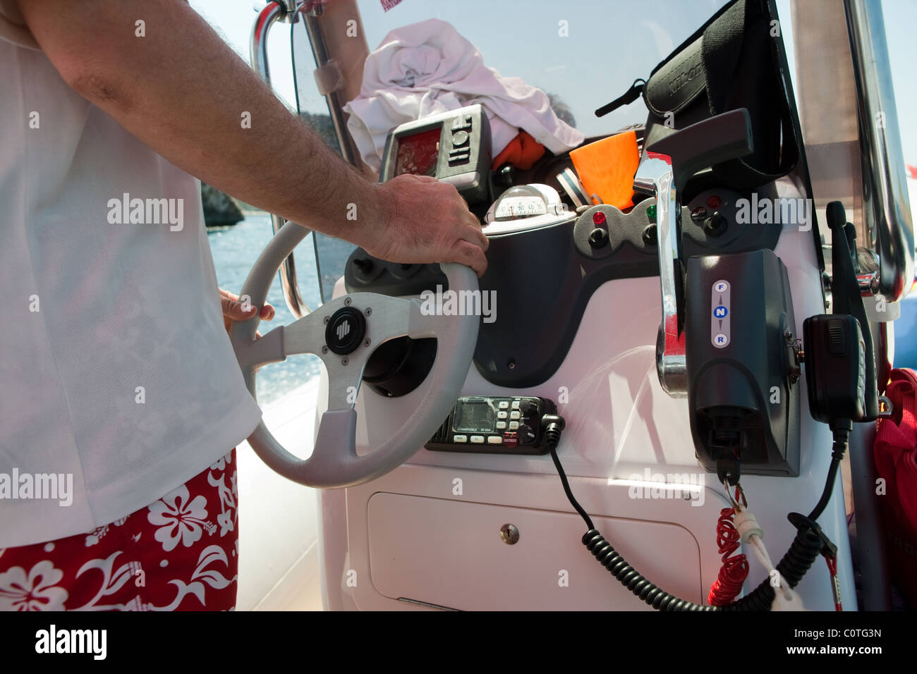 Man driving boat yacht "mid section" close Stock Photo - Alamy