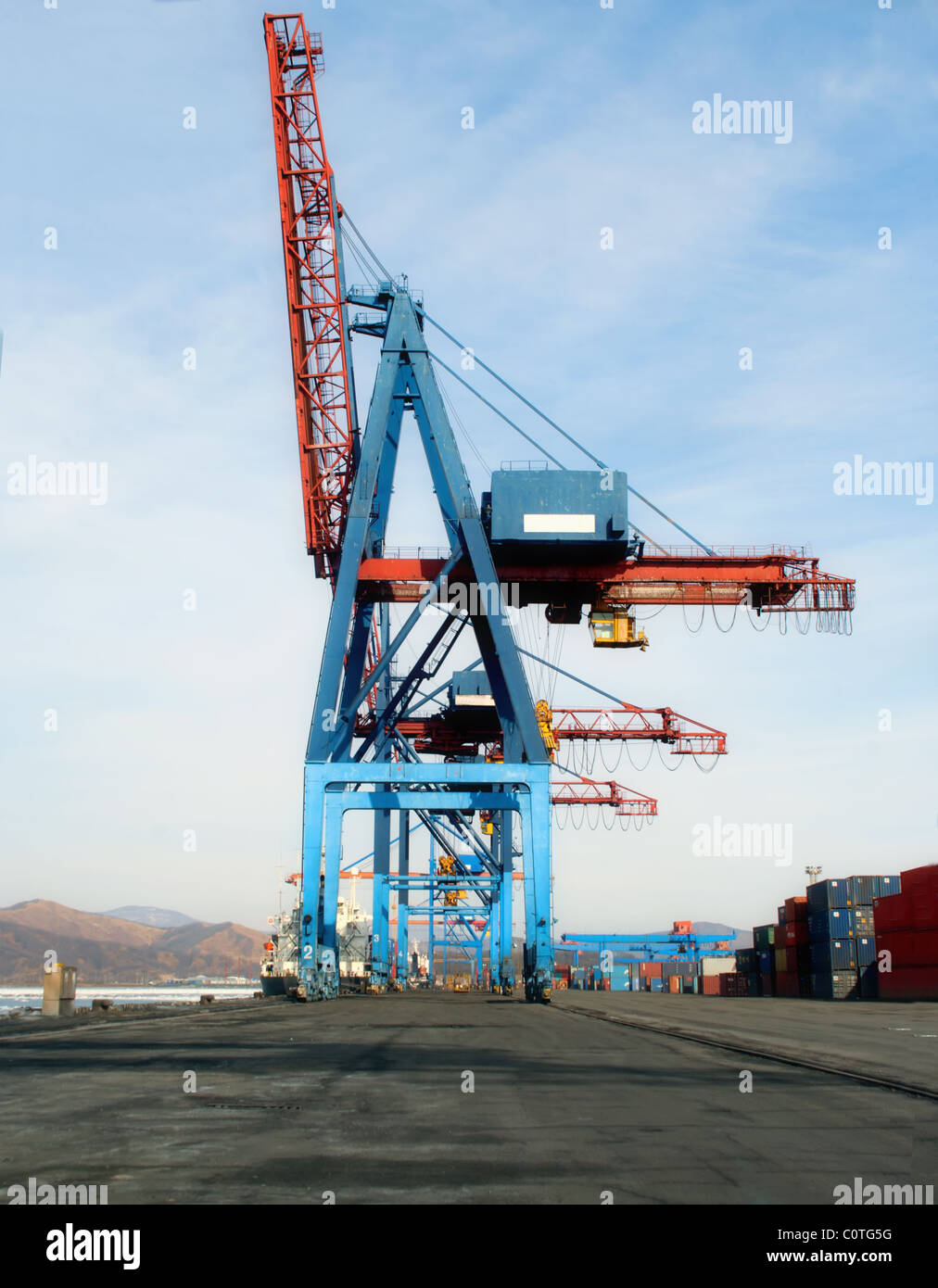 Cargo dock crane with stacks of containers Stock Photo - Alamy