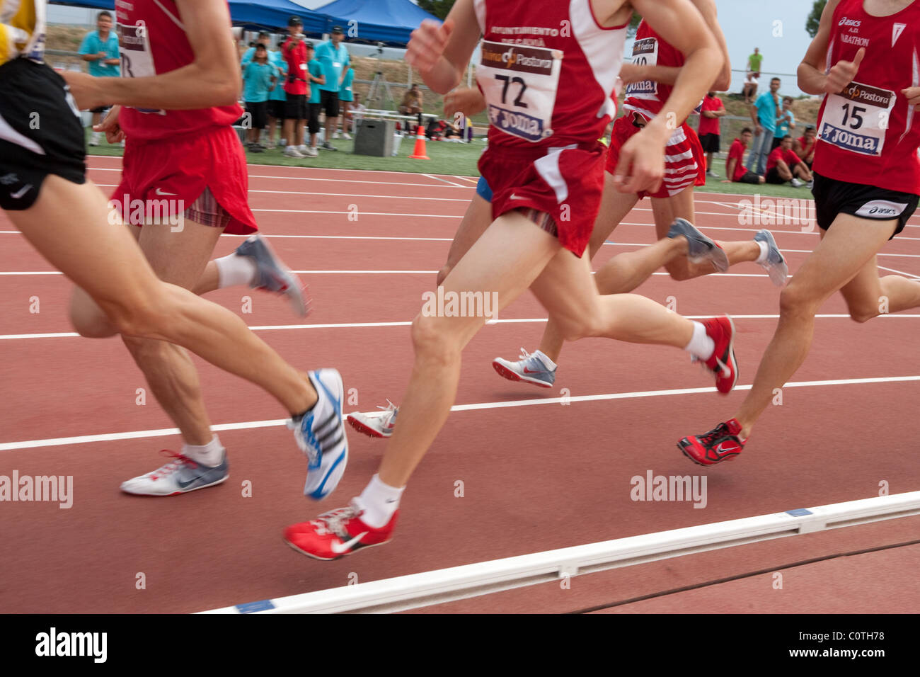 Adult racers athletes running legs close. Sport outdoor Athletics race ...