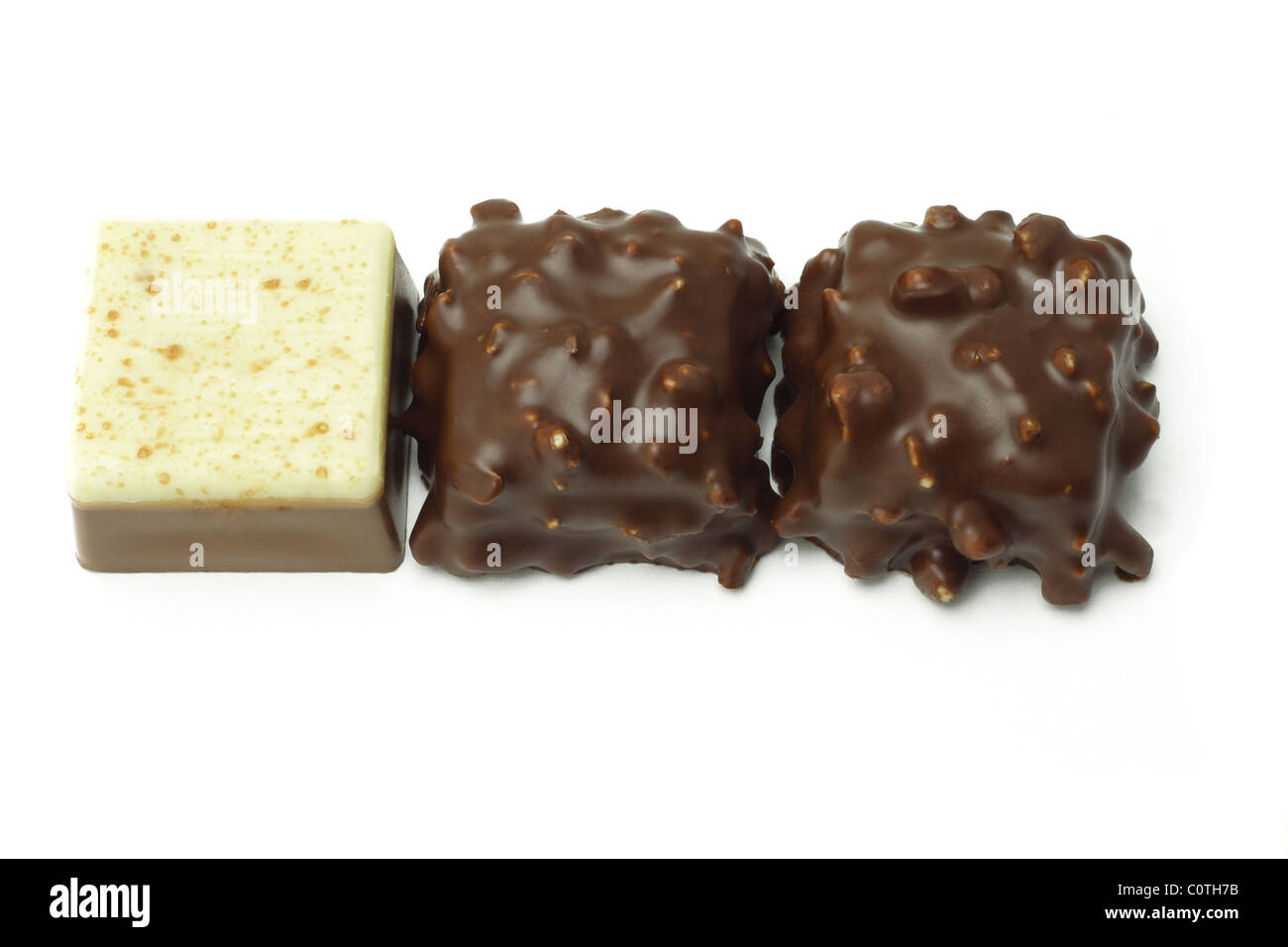Row of three chocolate cubes on white background Stock Photo - Alamy