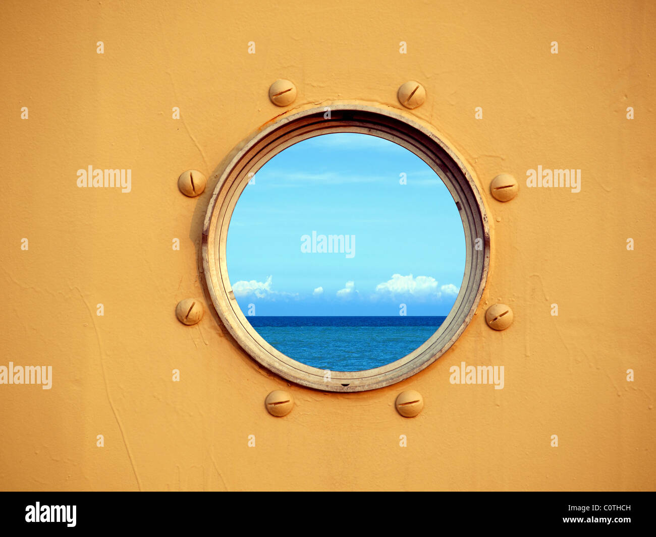 Looking through a porthole of a ship one can see the blue ocean and sky ...