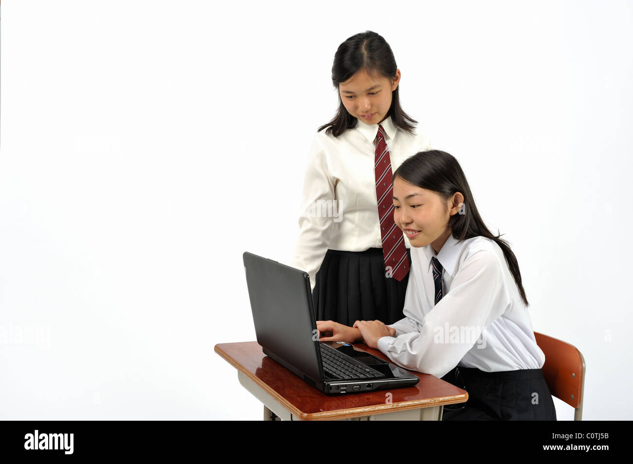 High School Girls Looking at Personal Computer Stock Photo - Alamy