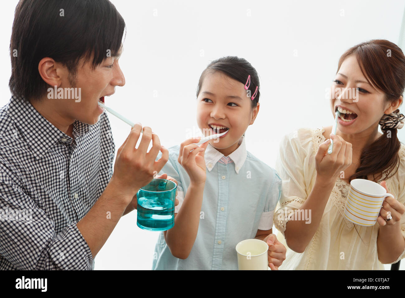 Family Brushing Teeth Together Stock Photo - Alamy