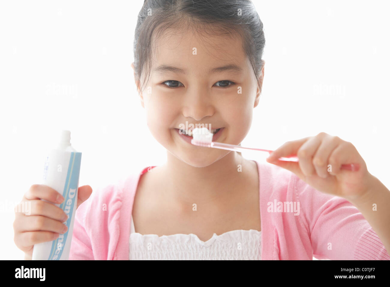 Girl Looking Toothpaste on Toothbrush Stock Photo - Alamy