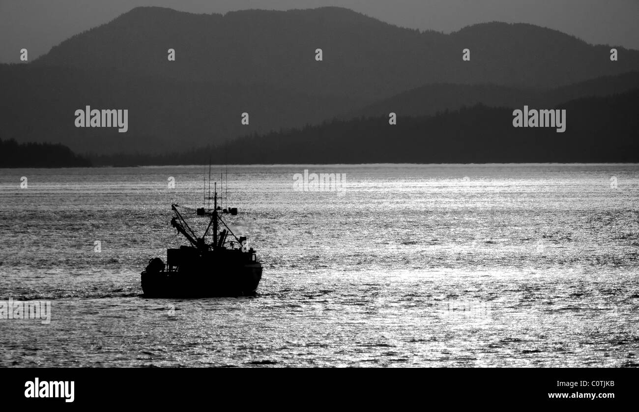 "An Alaska trawler heads out at sunset Stock Photo - Alamy