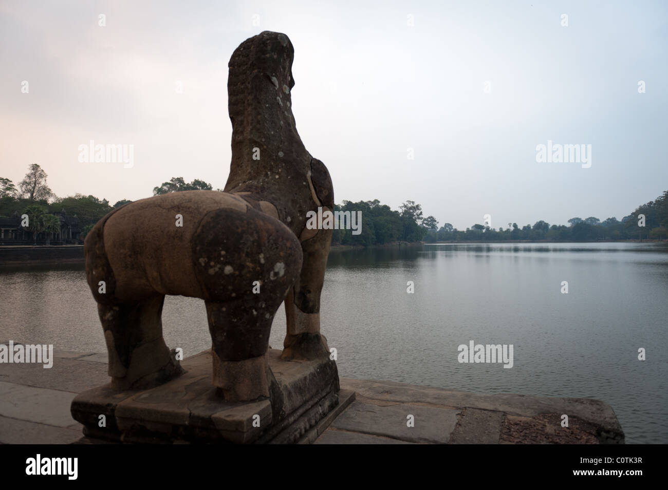 A mythical garuda beast statue stands guard at the moat of Angkor Wat ...