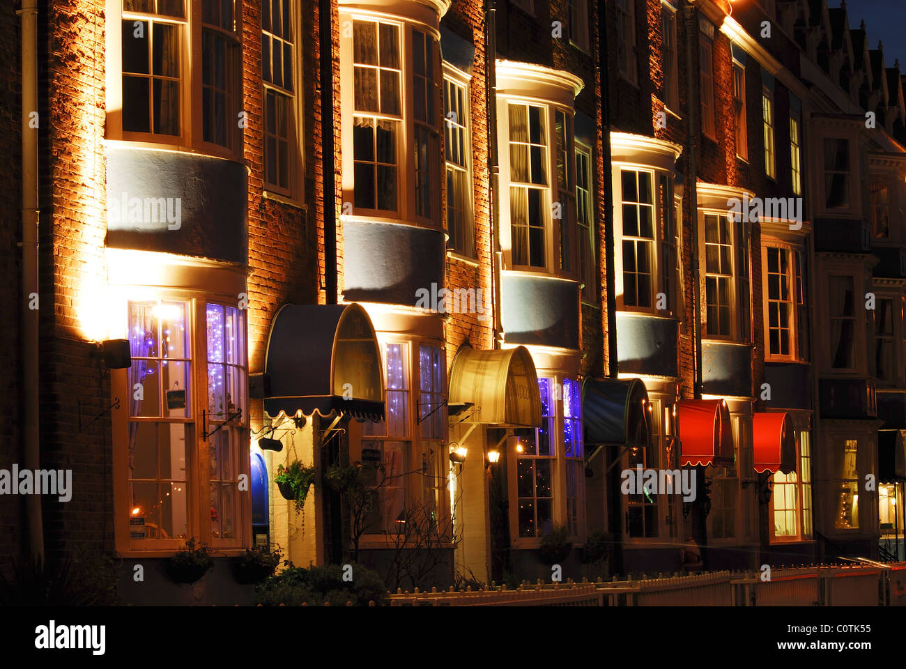 Terrace in Weymouth lit up at night, Dorset, UK December 2009 Stock ...