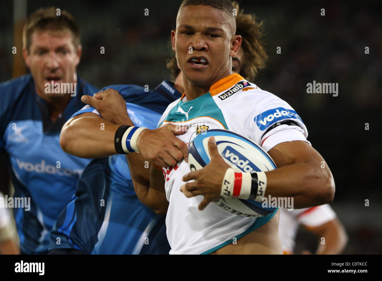 Ryno Benjamin is bought to ground by the Bulls full Back Zane Kirchner ...