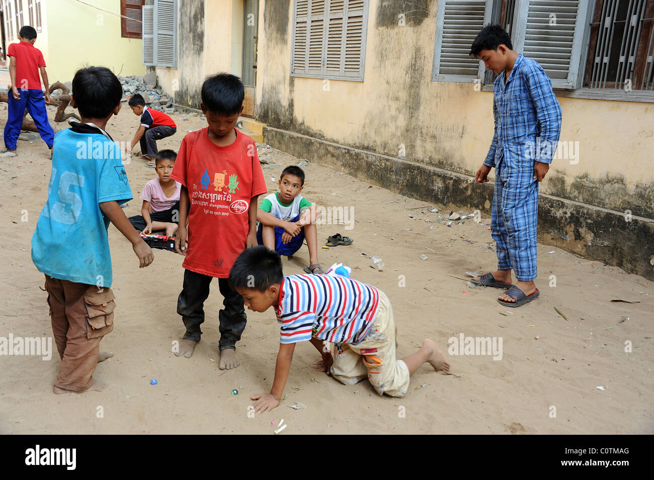 Children playing marbles game in hi-res stock photography and images ...